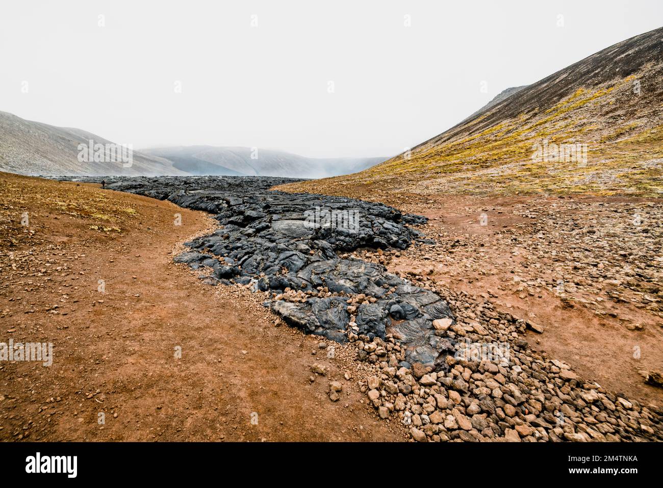 The ending of black volcanic rocks stoping in the valley near ...