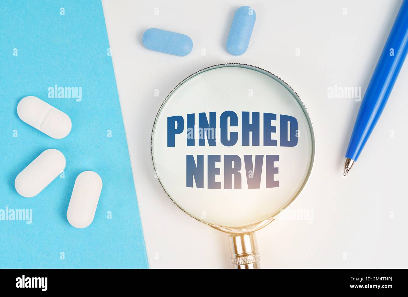 Medical concept. On a white and blue surface are pills, a pen and a ...