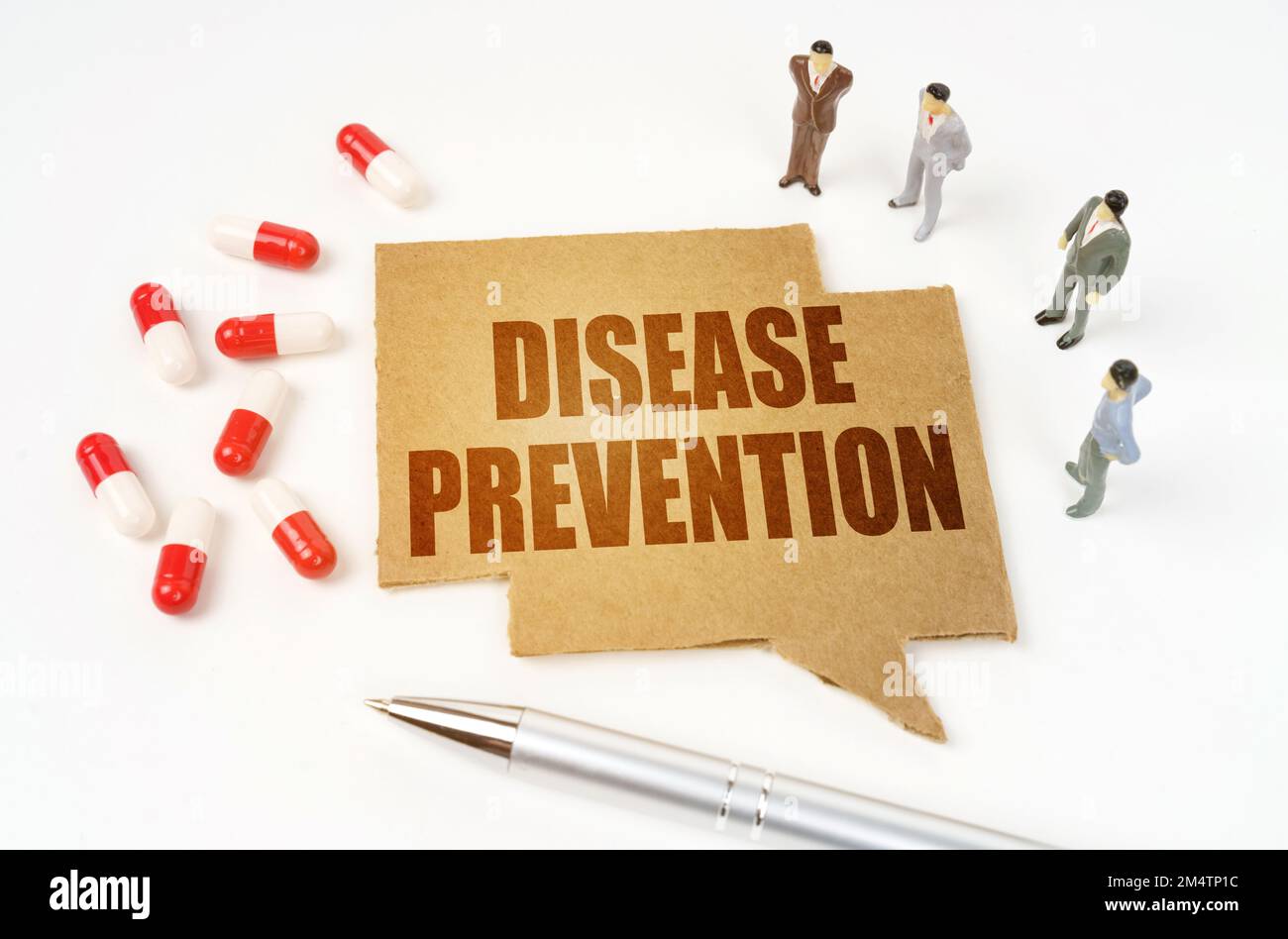 Medical concept. On a white surface are pills, a pen, miniature ...