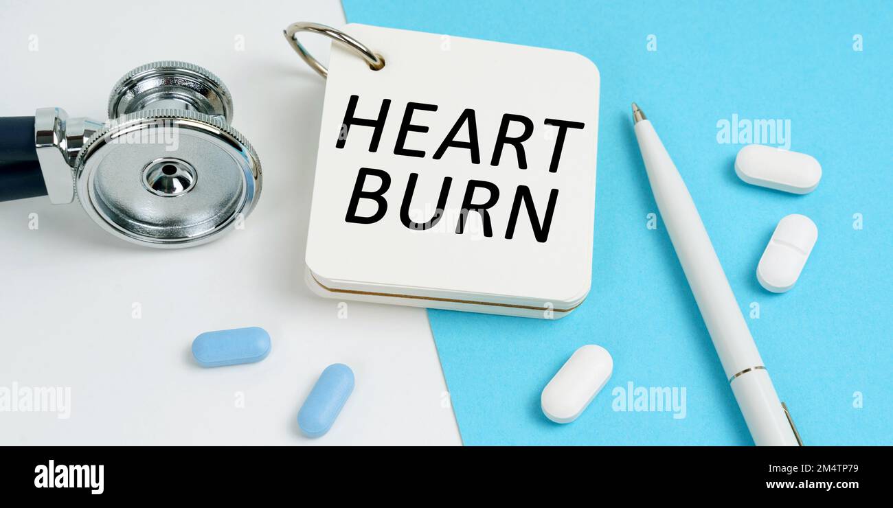 Medical concept. On a white and blue surface are pills, a stethoscope ...