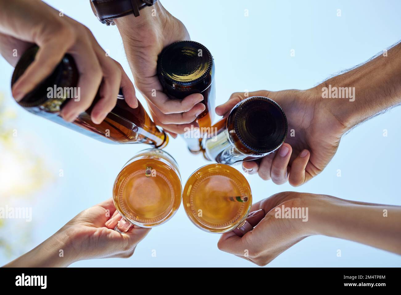 Toasting to the good life. Low angle shot of a young group of friends ...