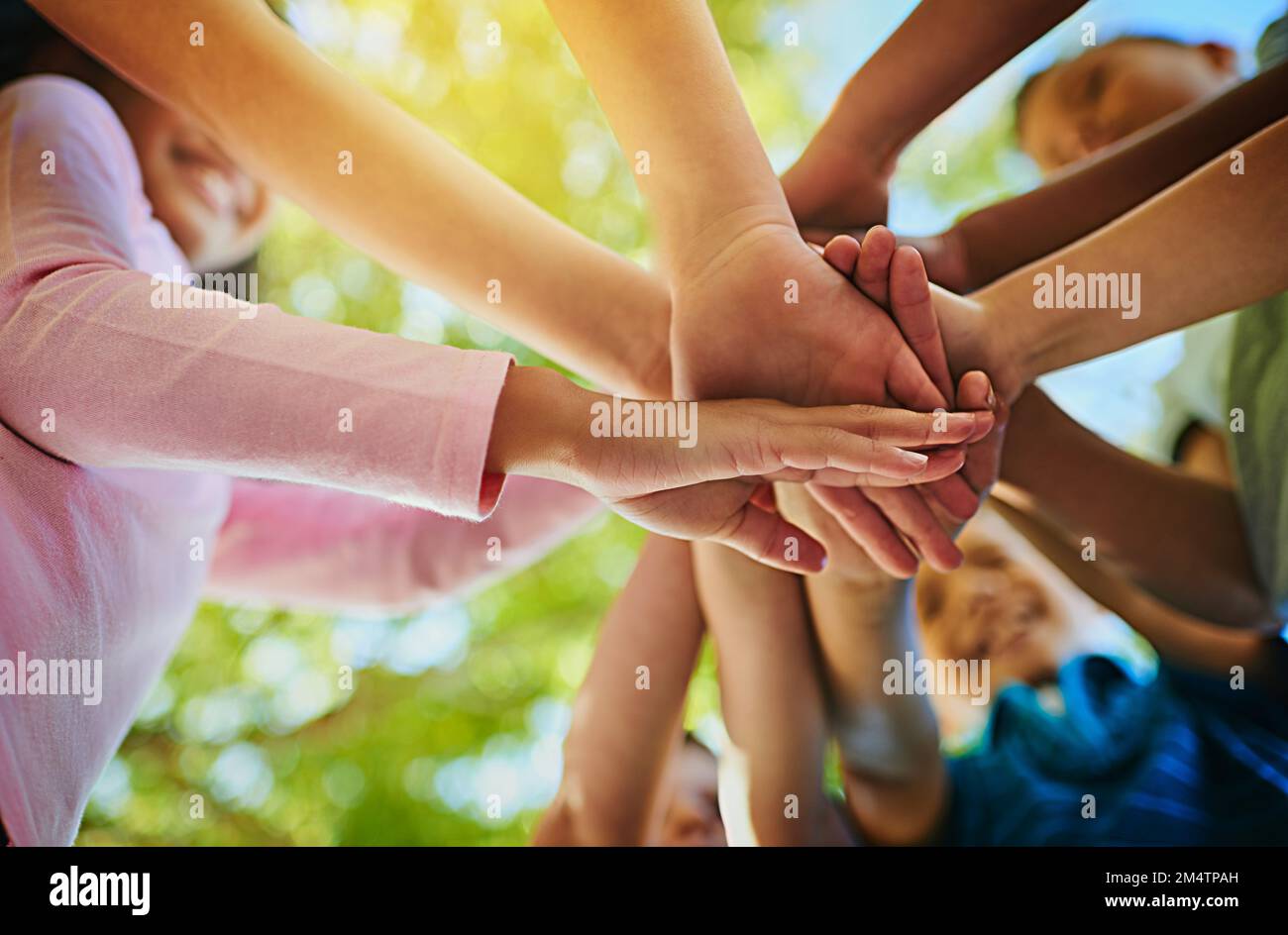 We all in this together. an unrecognizable group of young friends hands ...