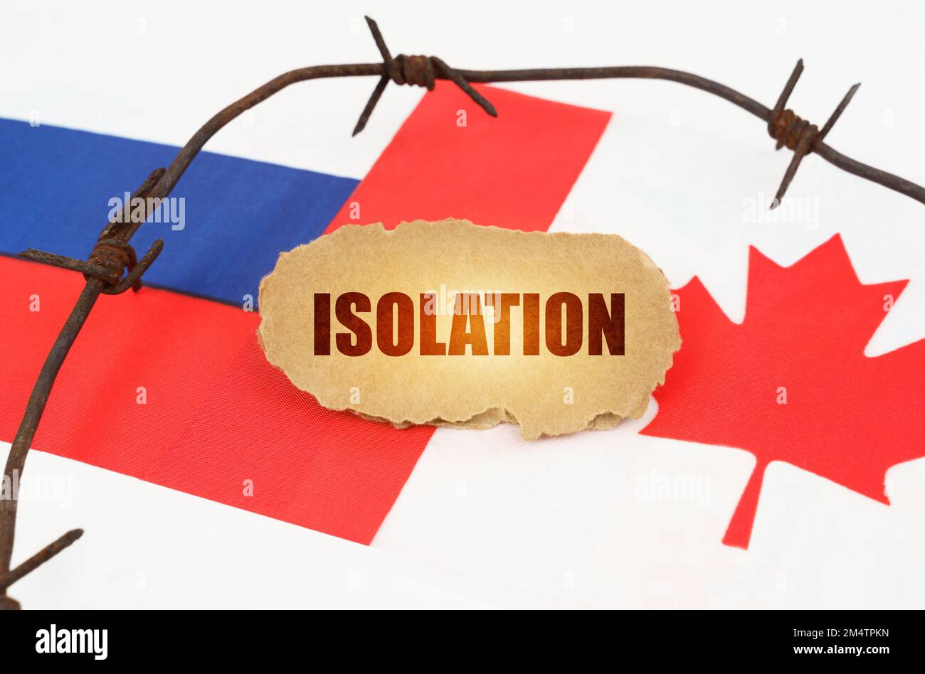 Political concept. On the flags of Canada and Russia lies a cardboard ...