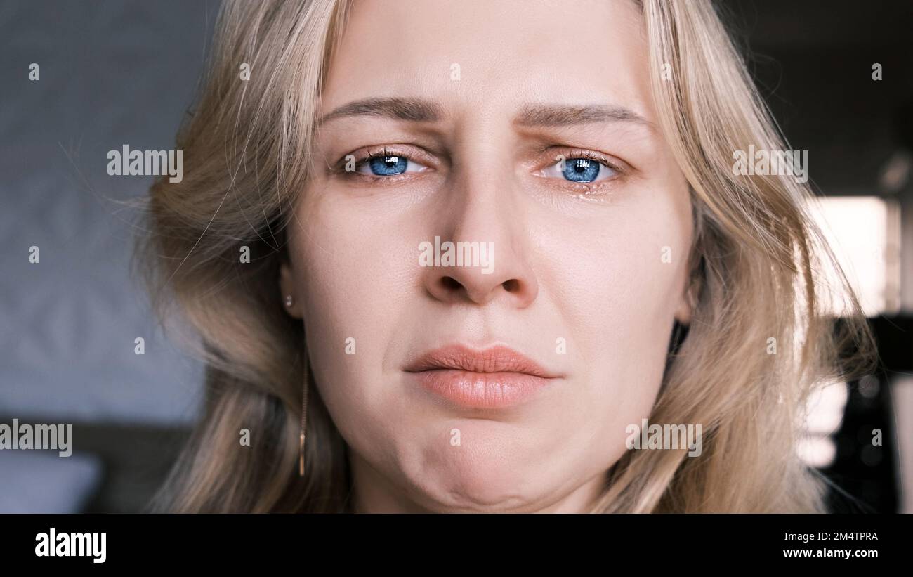 Portrait of crying grieving woman of 30 years. Grimace of sadness with ...