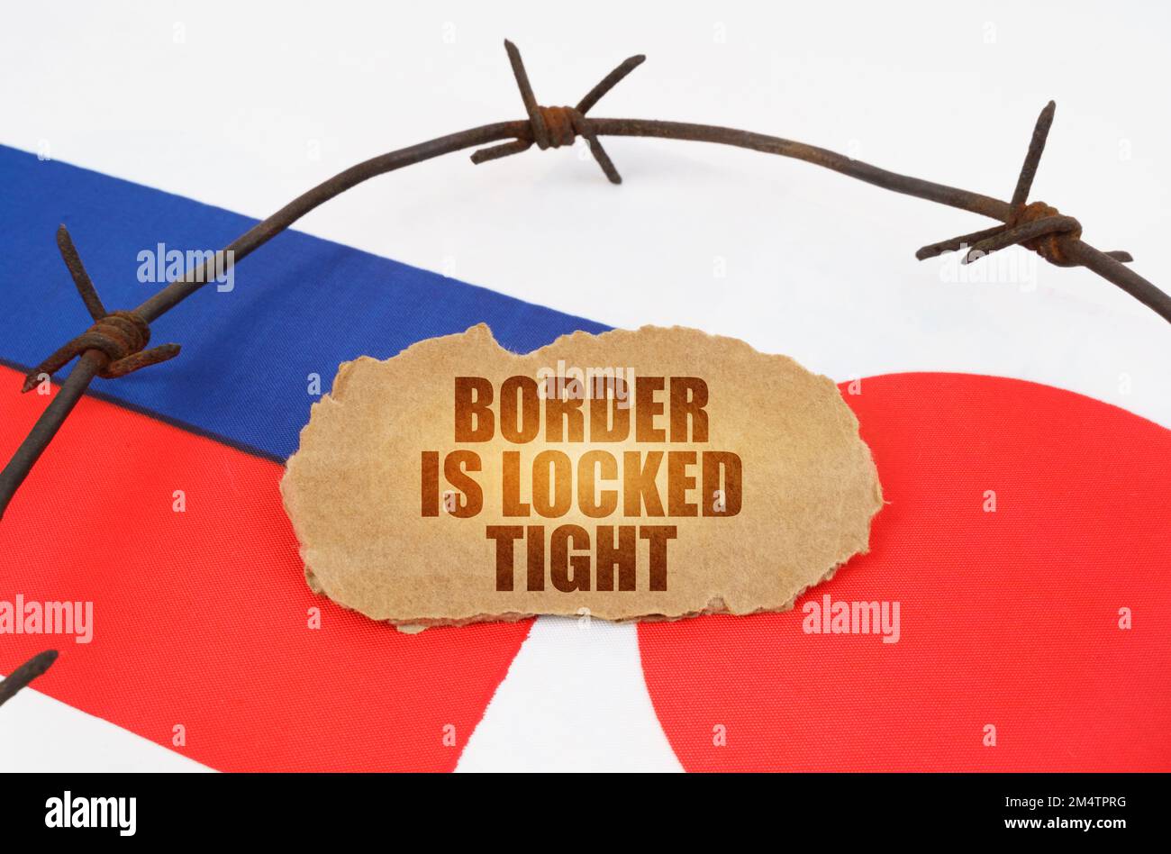 Political concept. On the flags of Japan and Russia lies a cardboard ...