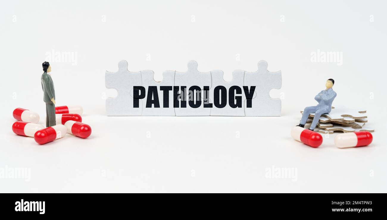 Medical concept. On the white surface of the tablet, miniature human ...