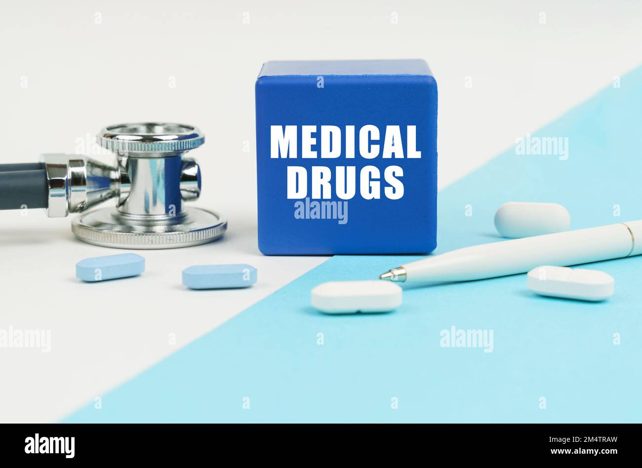 Medical concept. On a white and blue surface are pills, a stethoscope ...