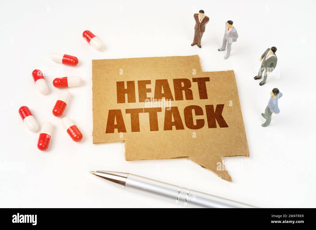 Medical concept. On a white surface are pills, a pen, miniature ...