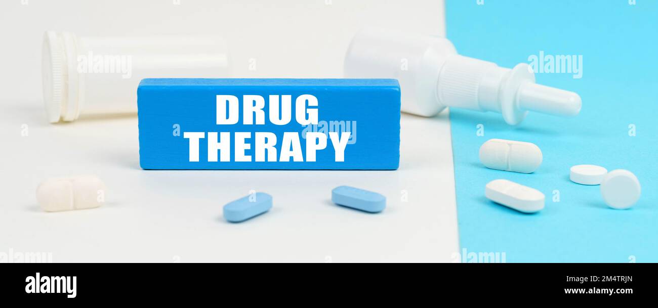 Medical concept. On a white and blue surface are pills, a spray and a ...