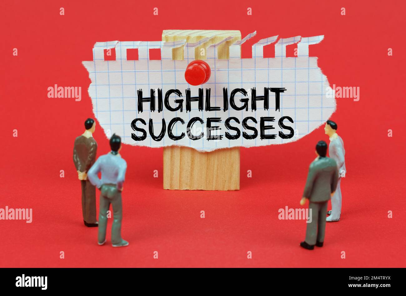 Business concept. On a red background are miniature figures of people ...