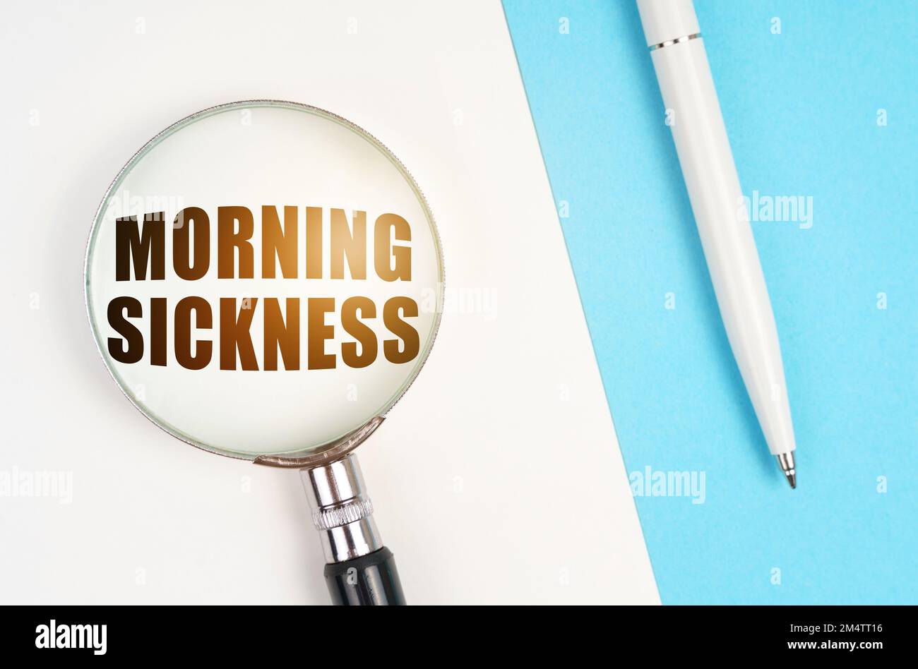 Medical concept. On a white - blue surface are a pen and a magnifying ...