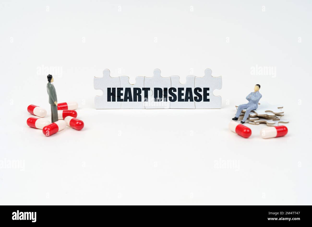 Medical concept. On the white surface of the tablet, miniature human ...