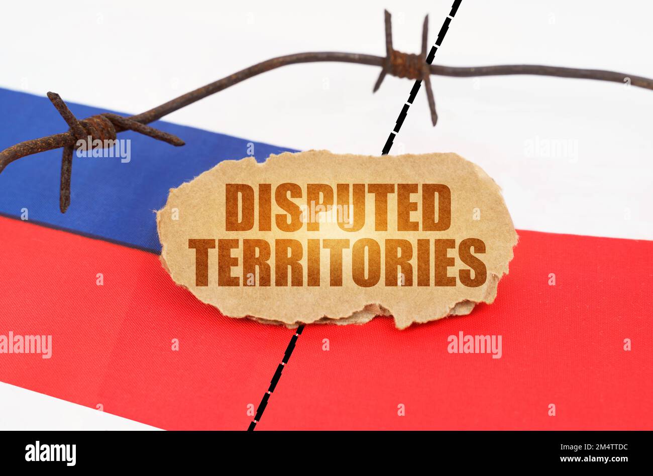 Political concept. On the flags of Poland and Russia lies a cardboard ...