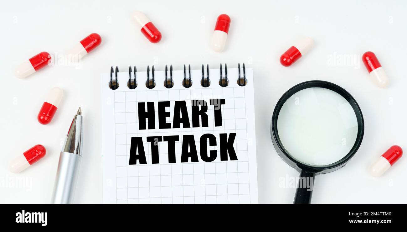 Medical concept. On a white surface are tablets, a pen, a magnifying ...