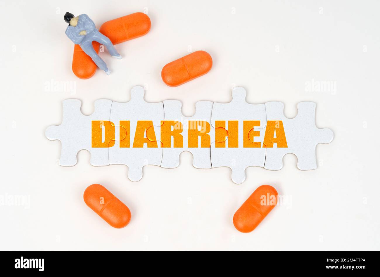 Medical concept. On the white surface of the tablet, a miniature human ...