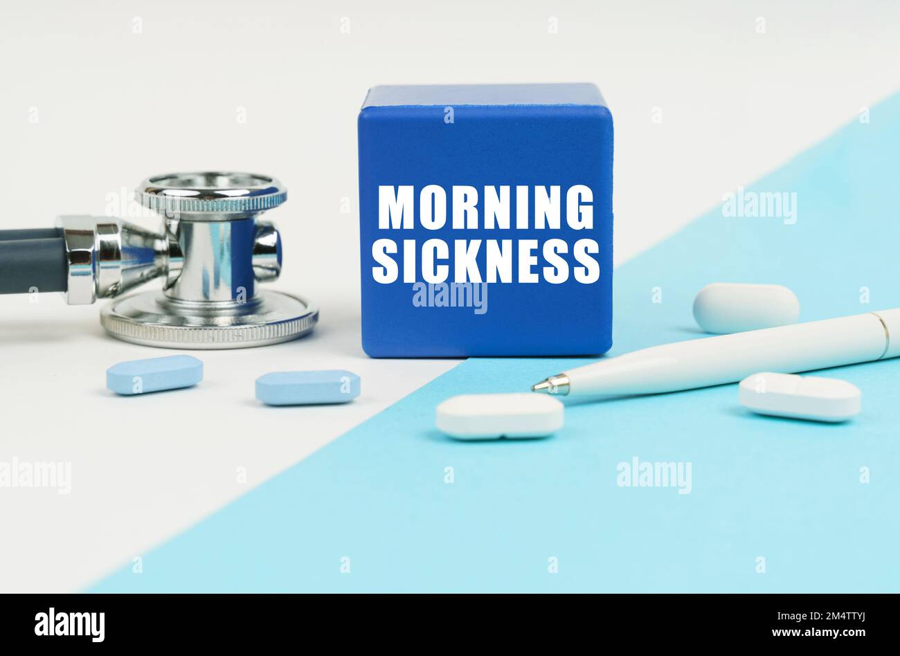 Medical concept. On a white and blue surface are pills, a stethoscope ...