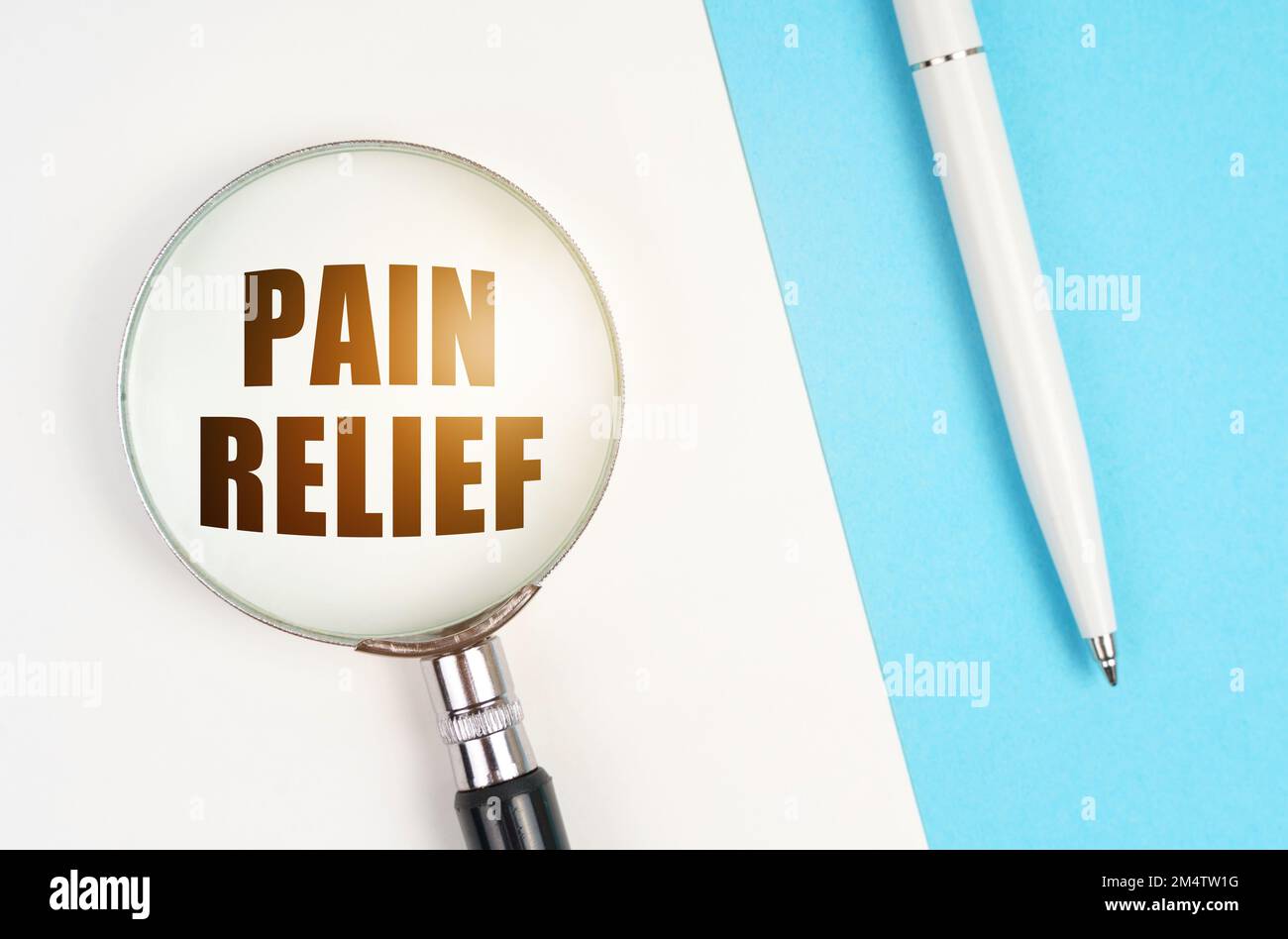 Medical concept. On a white - blue surface are a pen and a magnifying ...