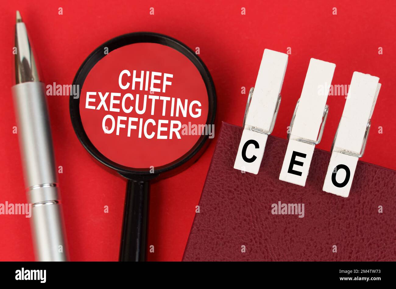 Business concept. On the red surface lies a pen, a notebook with ...