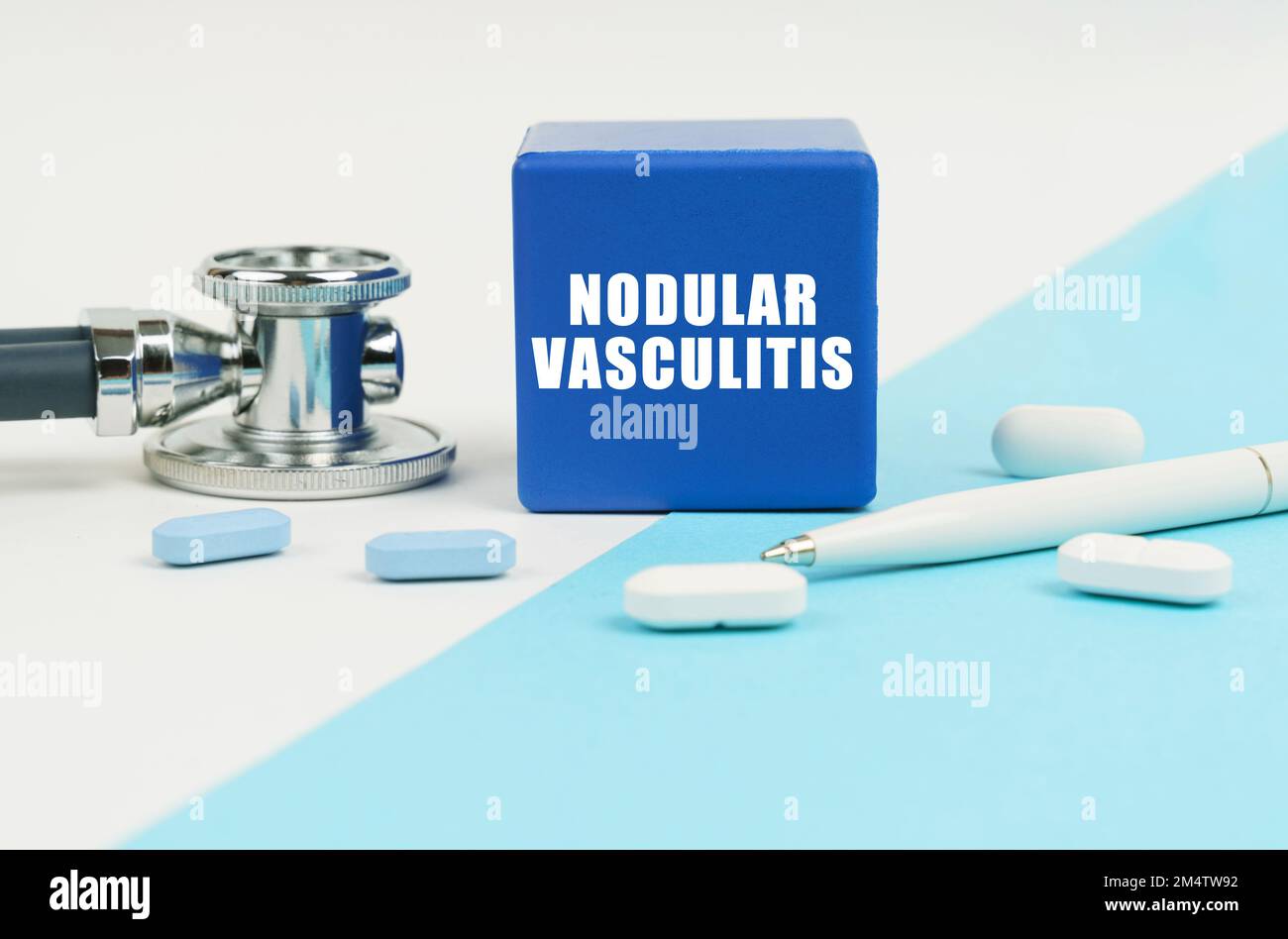 Medical concept. On a white and blue surface are pills, a stethoscope ...