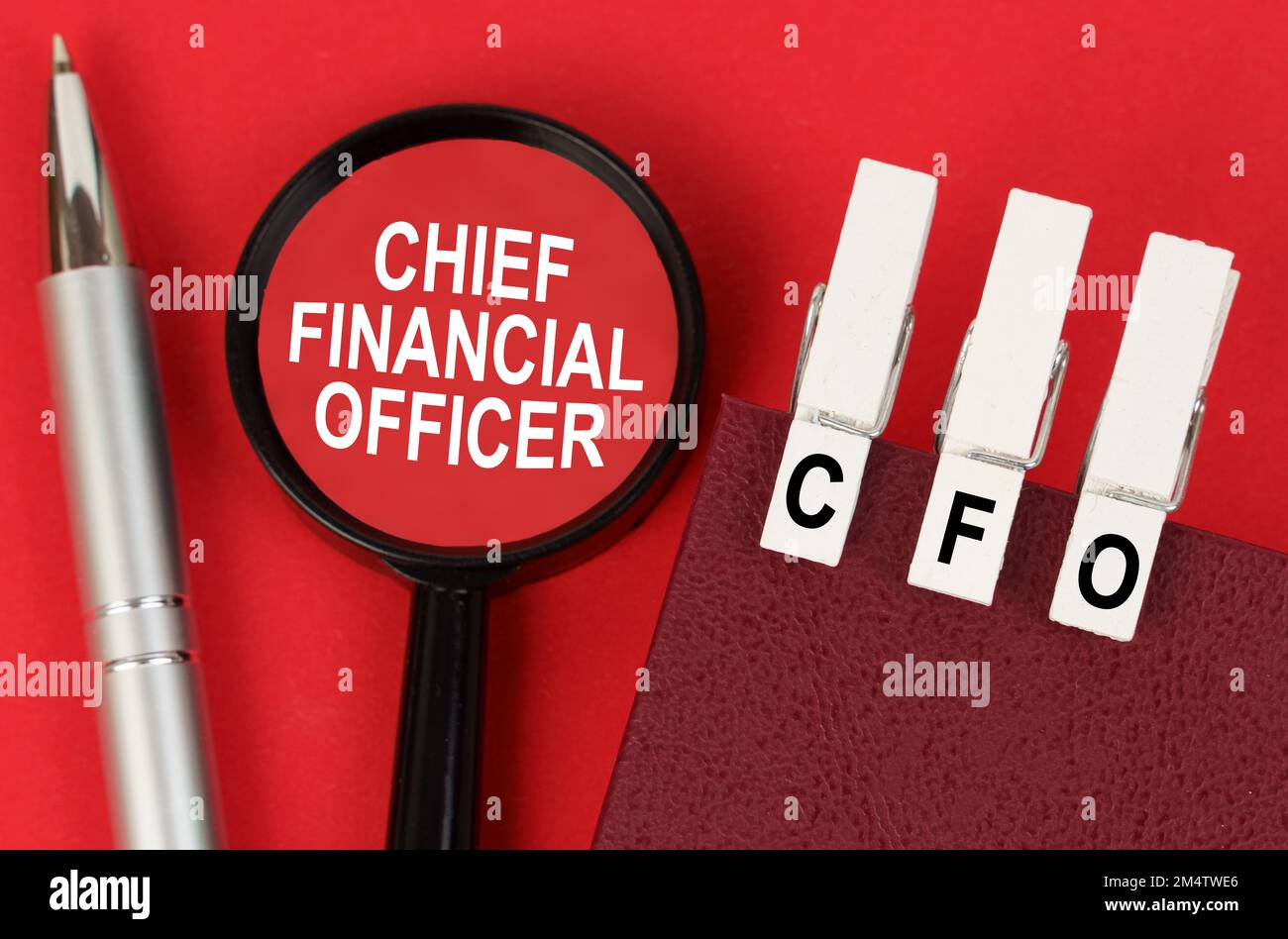 Business concept. On the red surface lies a pen, a notebook with ...