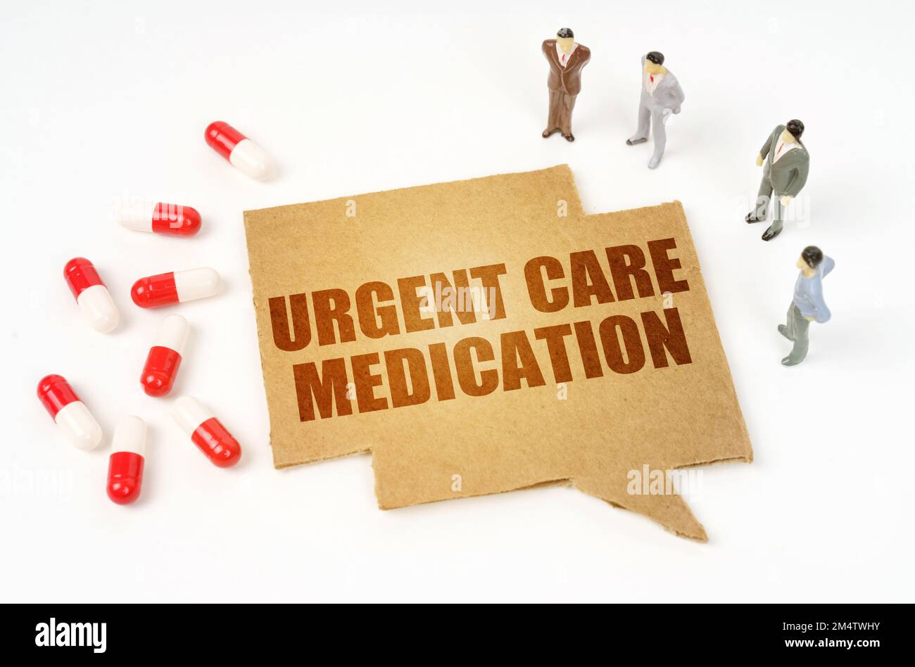 Medical concept. On a white surface are pills, a pen, miniature ...