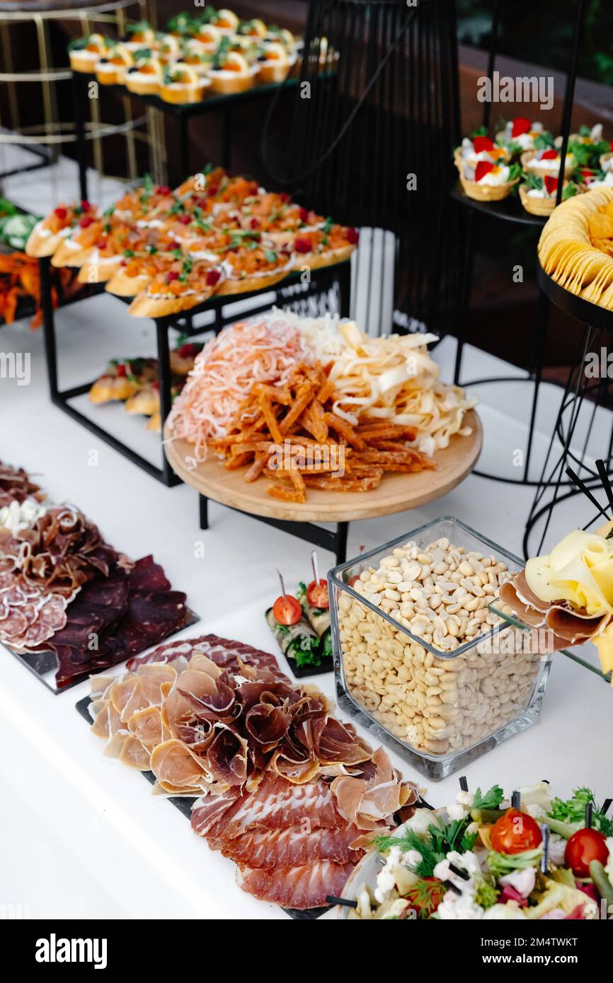 Buffet table of reception with cold snacks, meat and salads Stock Photo ...