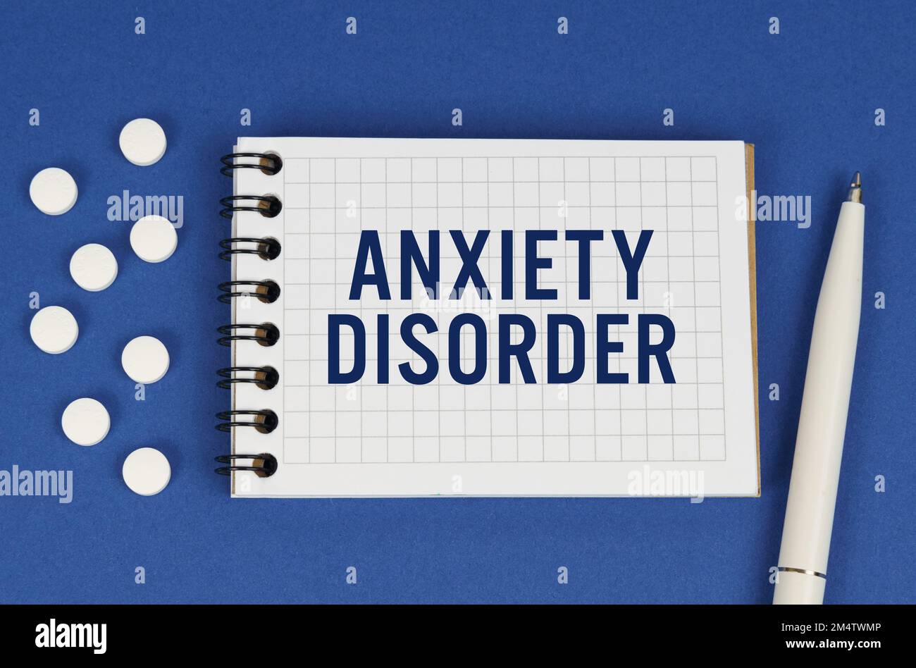 Medical concept. On a blue background, a pen, tablets and a notepad ...