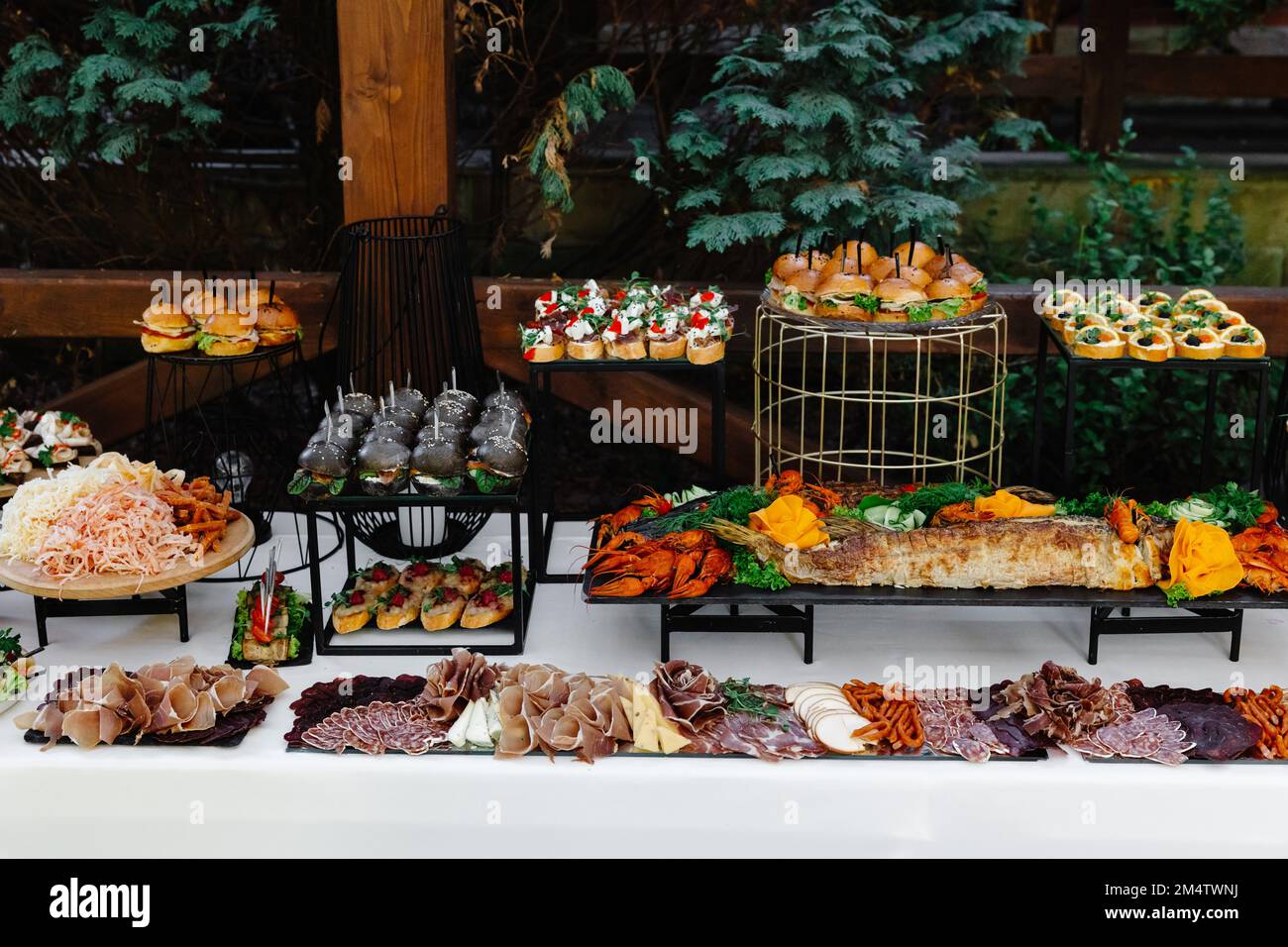Mini burgers snacks on a wooden table, beautifully decorated catering ...