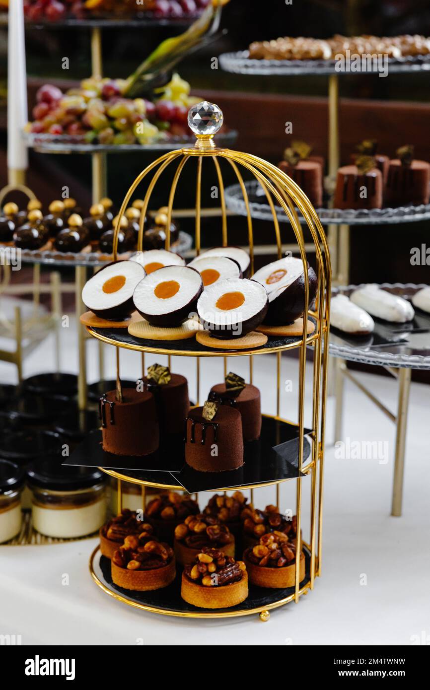 Many cakes standing among the candy bar. Sweet table. Banquet table ...