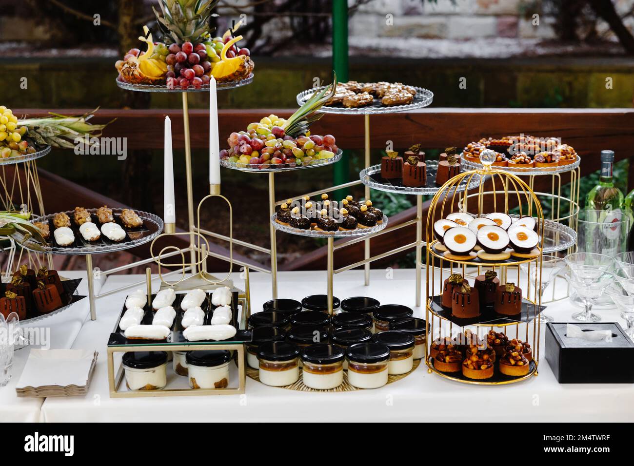 Many cakes standing among the candy bar. Sweet table. Banquet table ...
