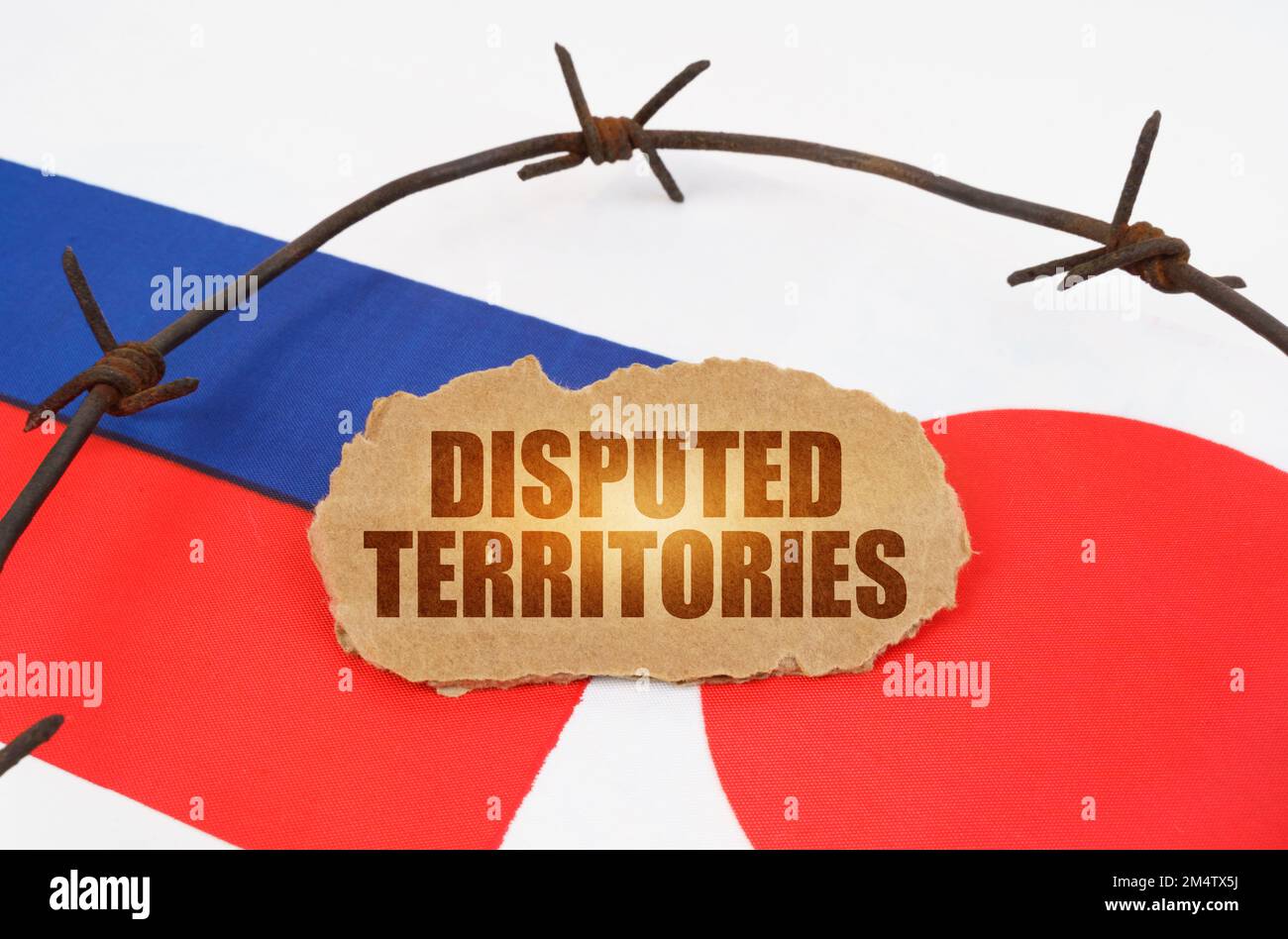 Political concept. On the flags of Japan and Russia lies a cardboard ...