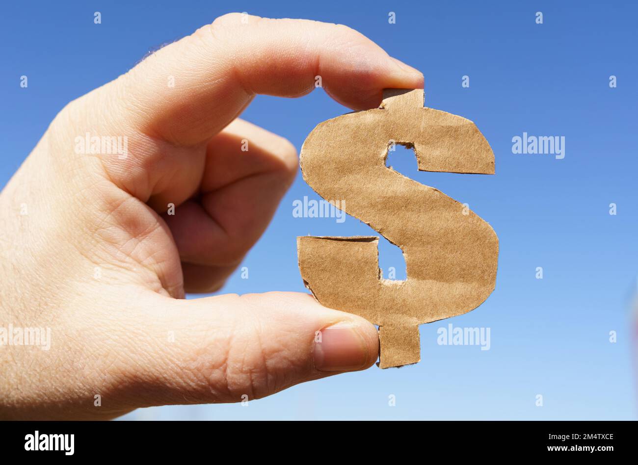 Currency symbols. Against the background of the sky in the hands of a ...