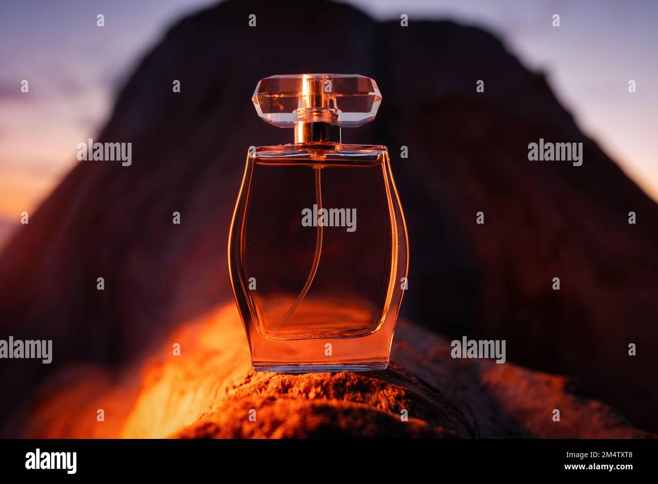 Perfumery industry and advertisement. Rounded glass golden perfume ...