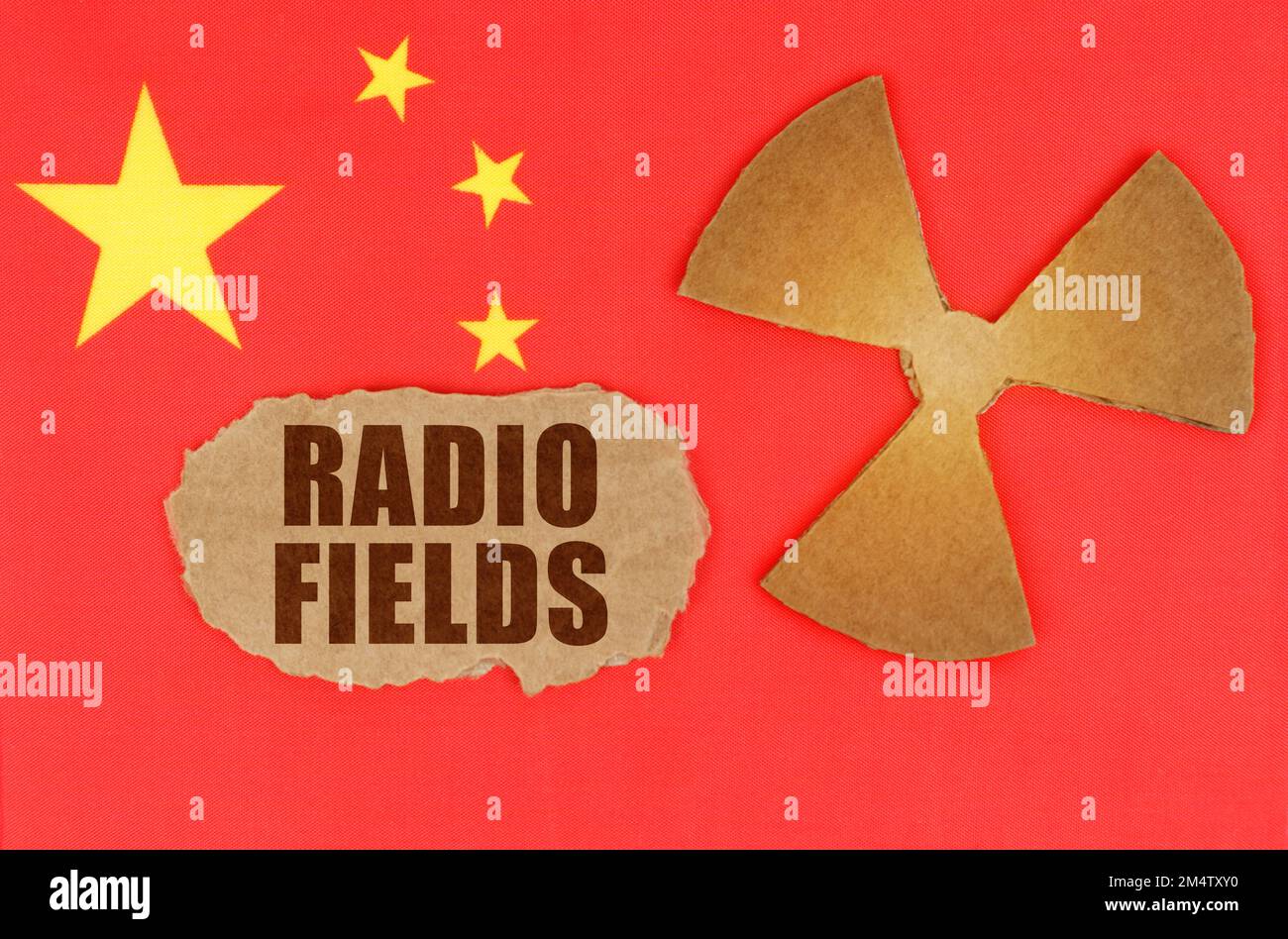 The concept of industry and radiation. On the flag of China, the symbol of radioactivity and ...