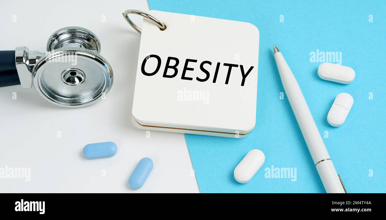 Medical concept. On a white and blue surface are pills, a stethoscope ...