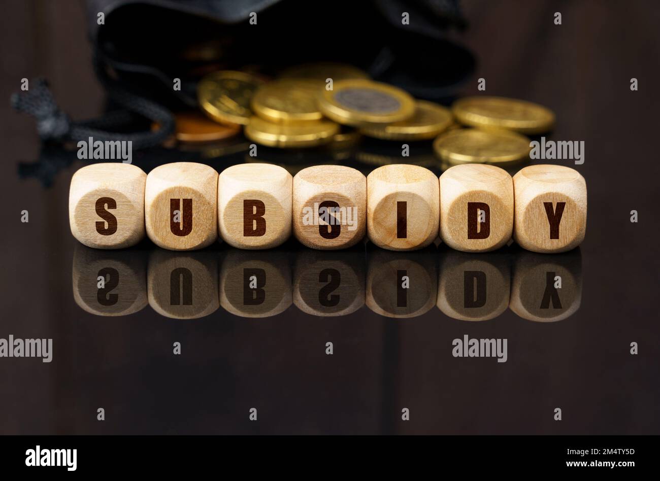 Business and economy concept. On a black reflective surface are coins ...