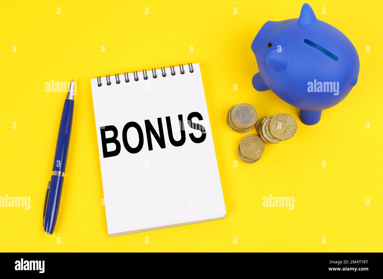 Business and finance concept. On a yellow surface, a piggy bank, coins ...