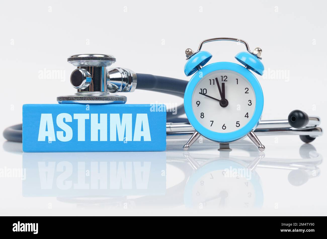 Medical concept. On a white surface there is an alarm clock, a ...