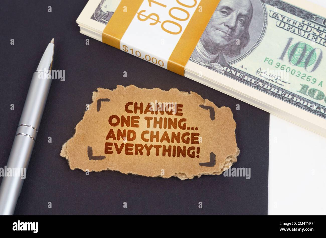 Business concept. On the table are dollars, a pen and a cardboard sign ...