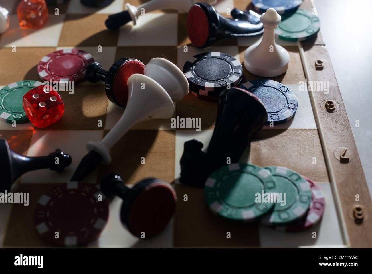 Wooden checkers, chess pieces, playing cards, board games on a light ...