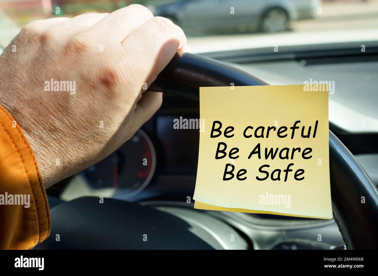 The concept of transport security. A man holds on to the steering wheel ...