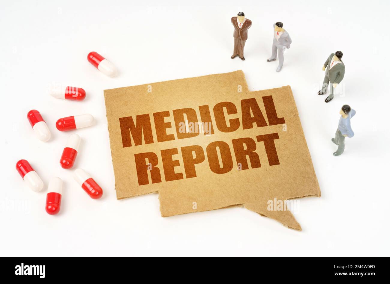 Medical concept. On a white surface are pills, a pen, miniature ...