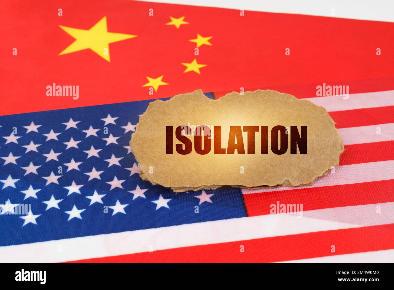 Political concept. On the flags of the USA and China lies a cardboard ...
