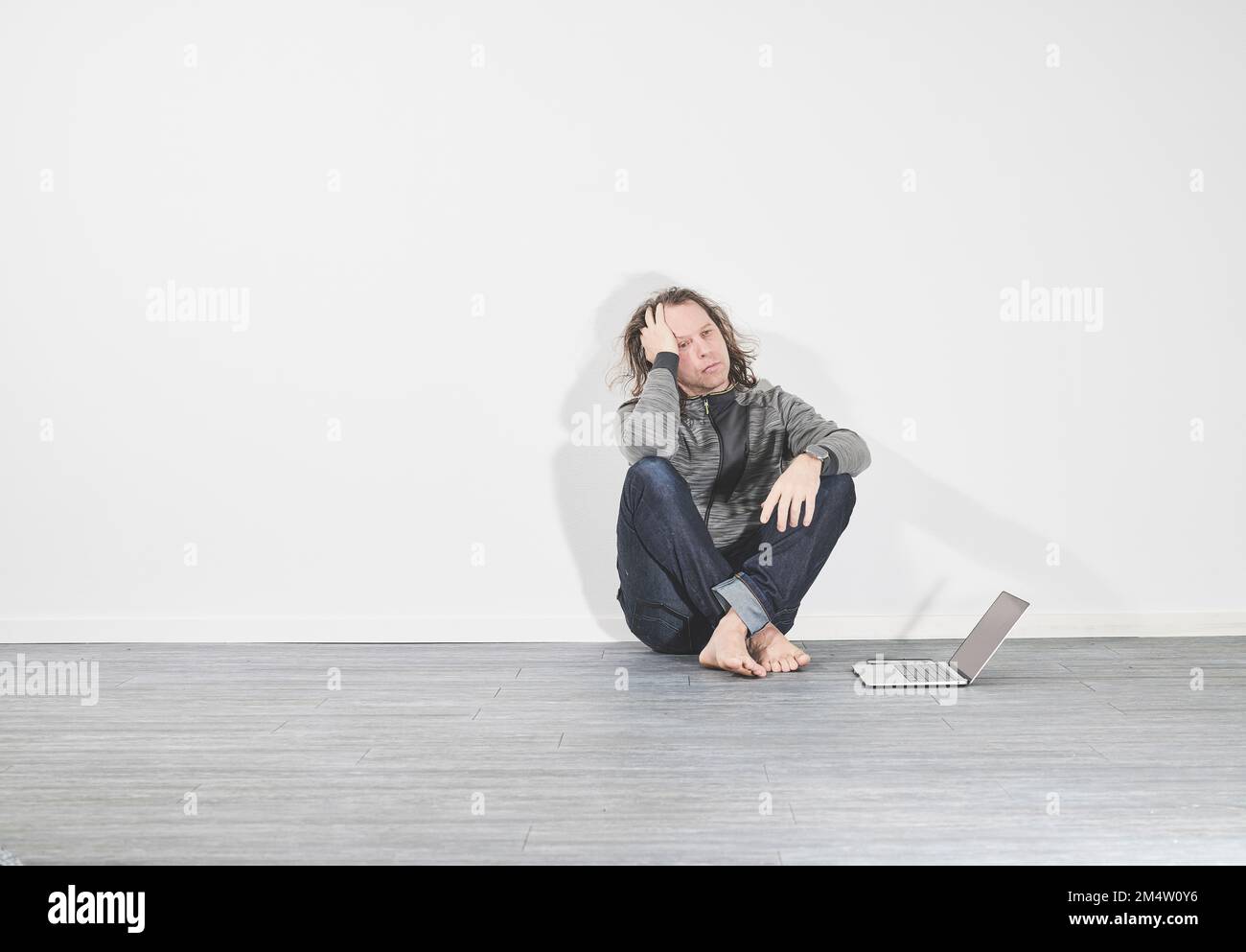 Man working with computer barefoot Stock Photo - Alamy