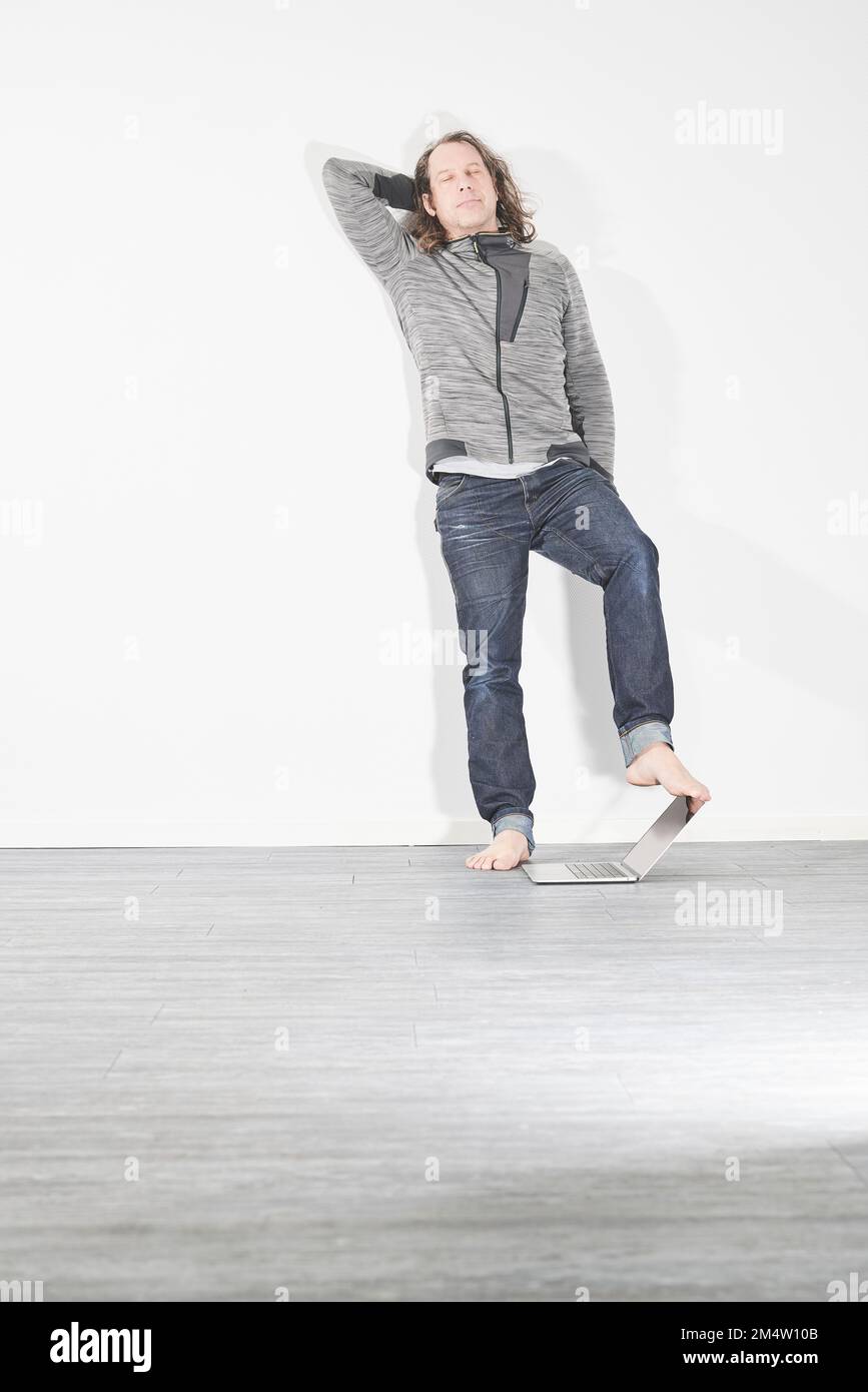 Man working with computer barefoot Stock Photo - Alamy