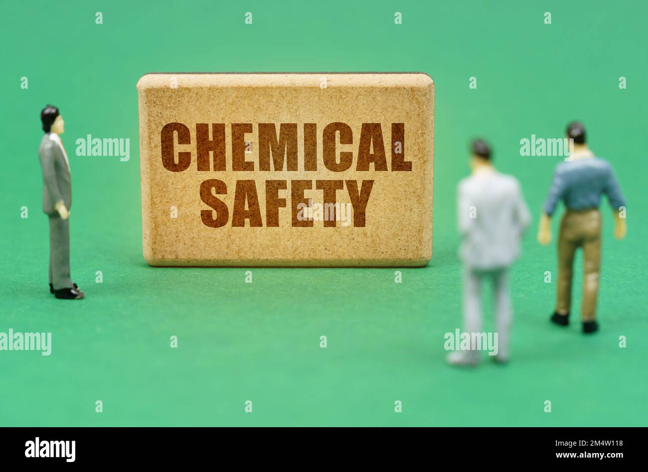 Security and insurance concept. On the green surface are figures of ...