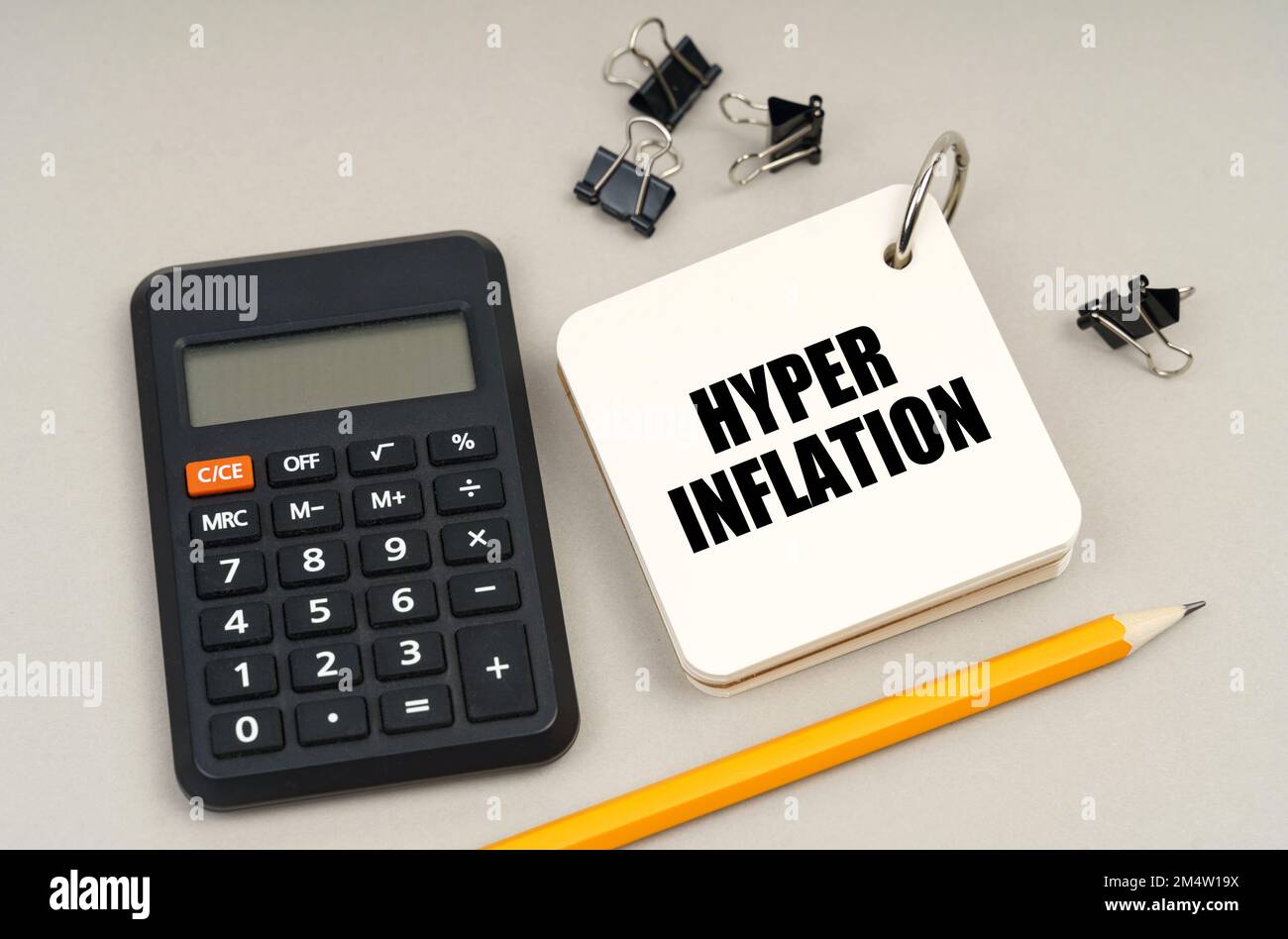 Business concept. On a gray surface, a calculator, a pencil and a ...