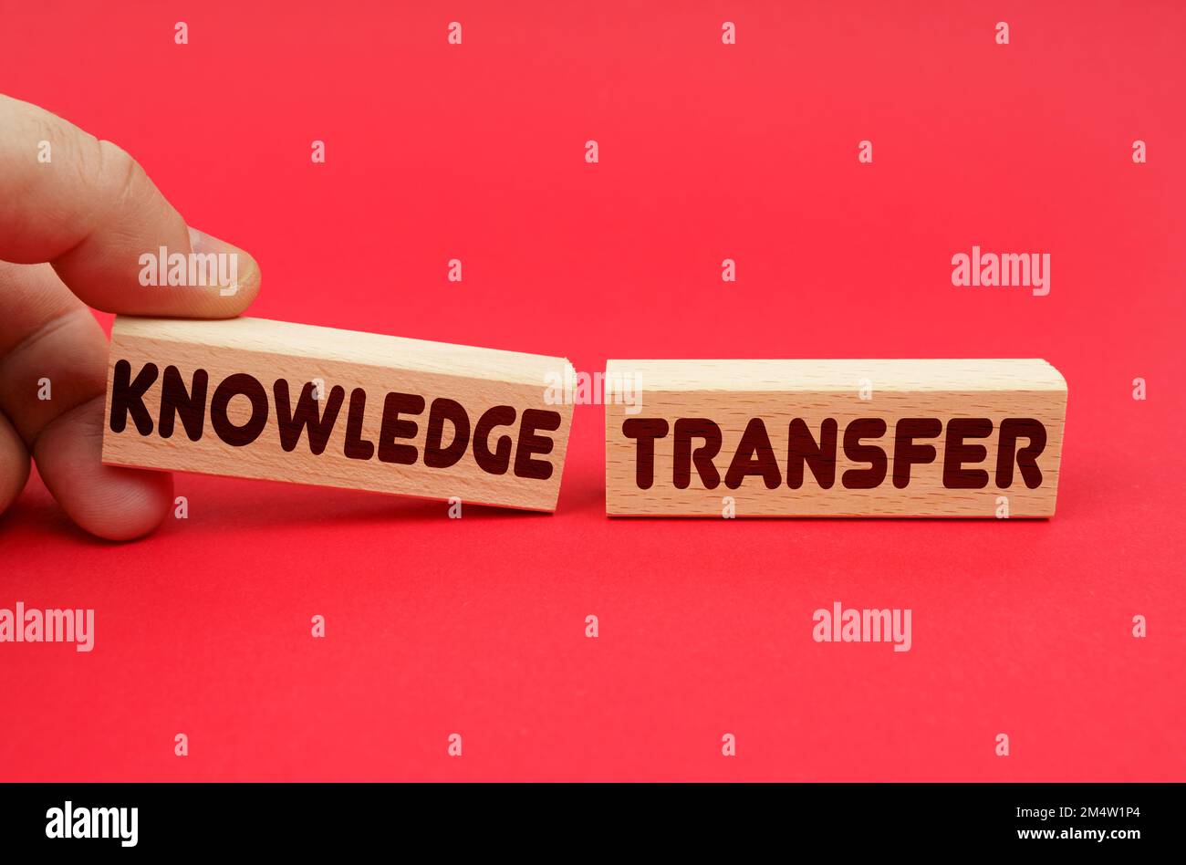 Business concept. On a red background, wooden blocks, one of them in ...