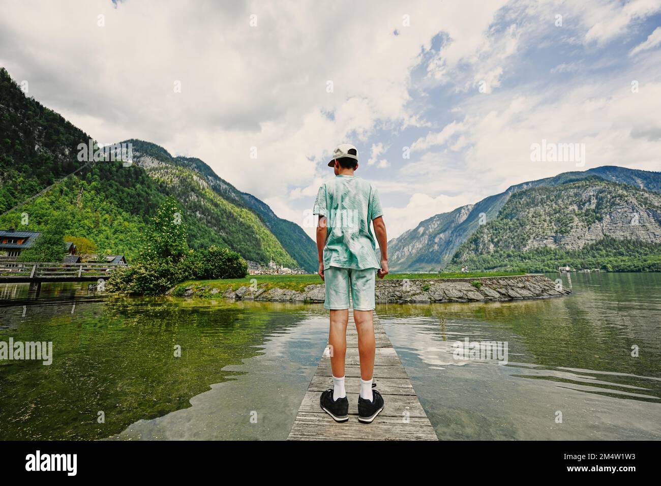 Back of boy stand on small wooden bridge at Hallstatt, Austria Stock ...