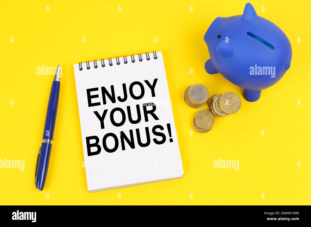 Business and finance concept. On a yellow surface, a piggy bank, coins ...